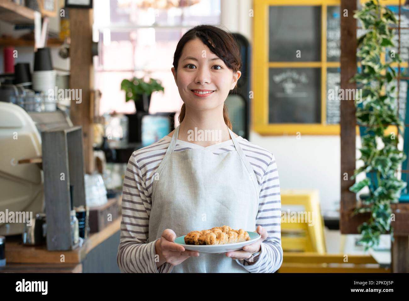 Asian woman eating bread hi-res stock photography and images - Alamy
