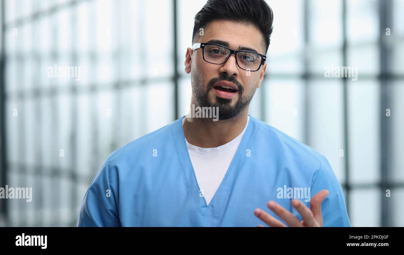 Head shot portrait male doctor talking online with patient, making ...