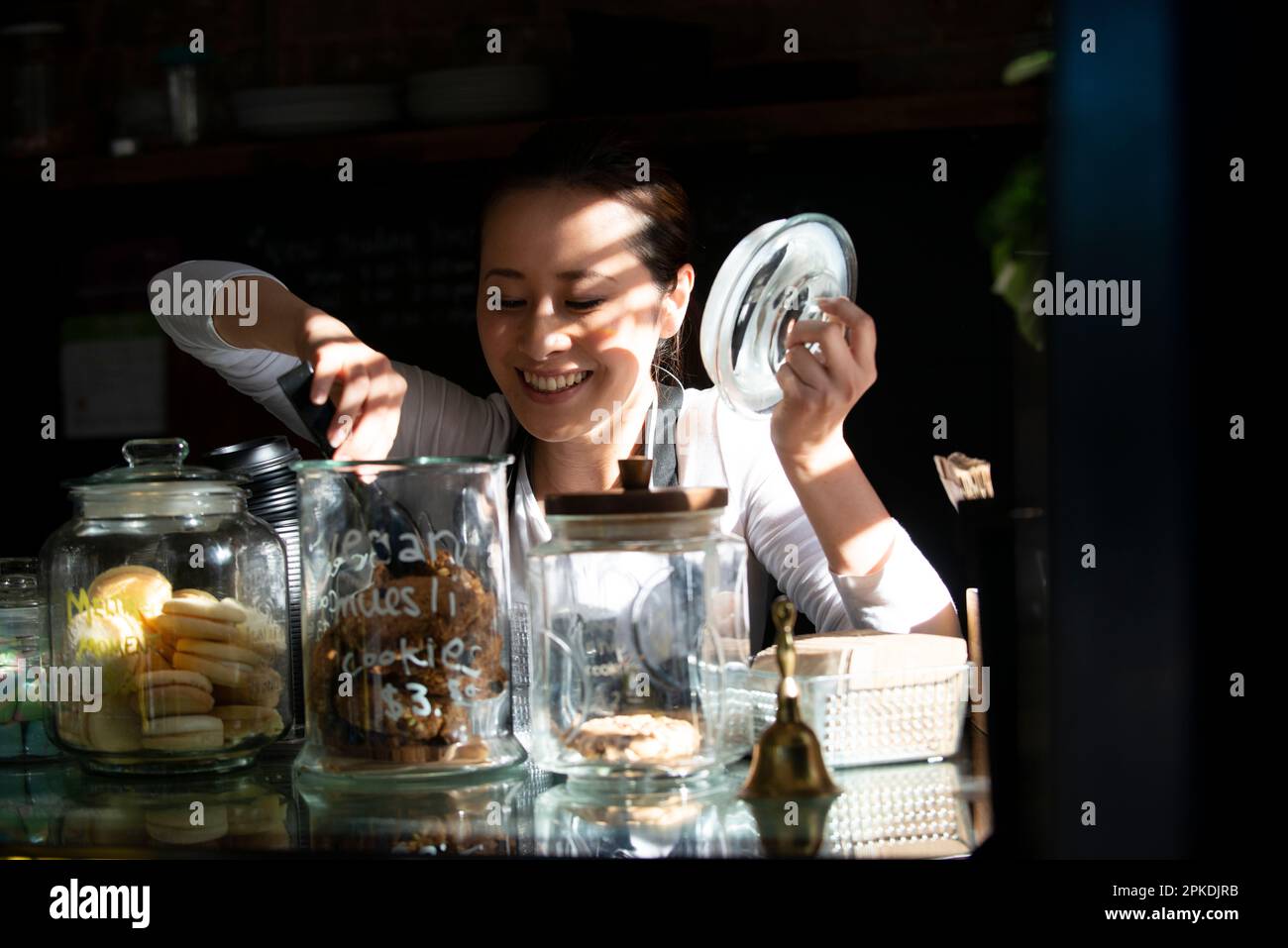 Female waitress working at a café Stock Photo - Alamy