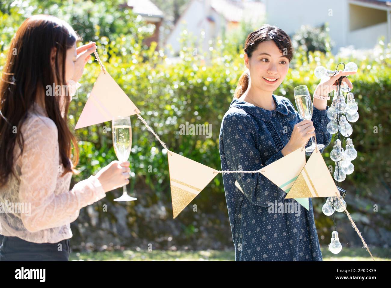 Two women decorating for a garden party Stock Photo - Alamy