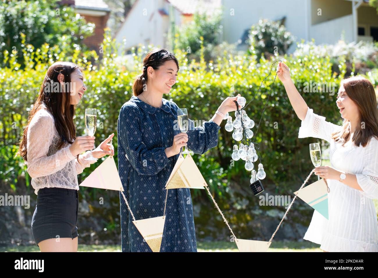 Three women preparing for a garden party with smiles on their faces ...