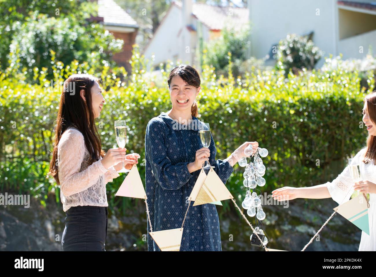 Three women enjoying the garden party with smiles Stock Photo - Alamy