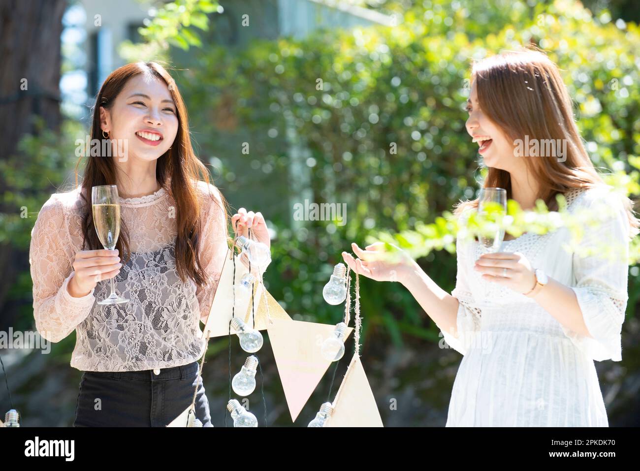 Two women decorating for a garden party Stock Photo - Alamy