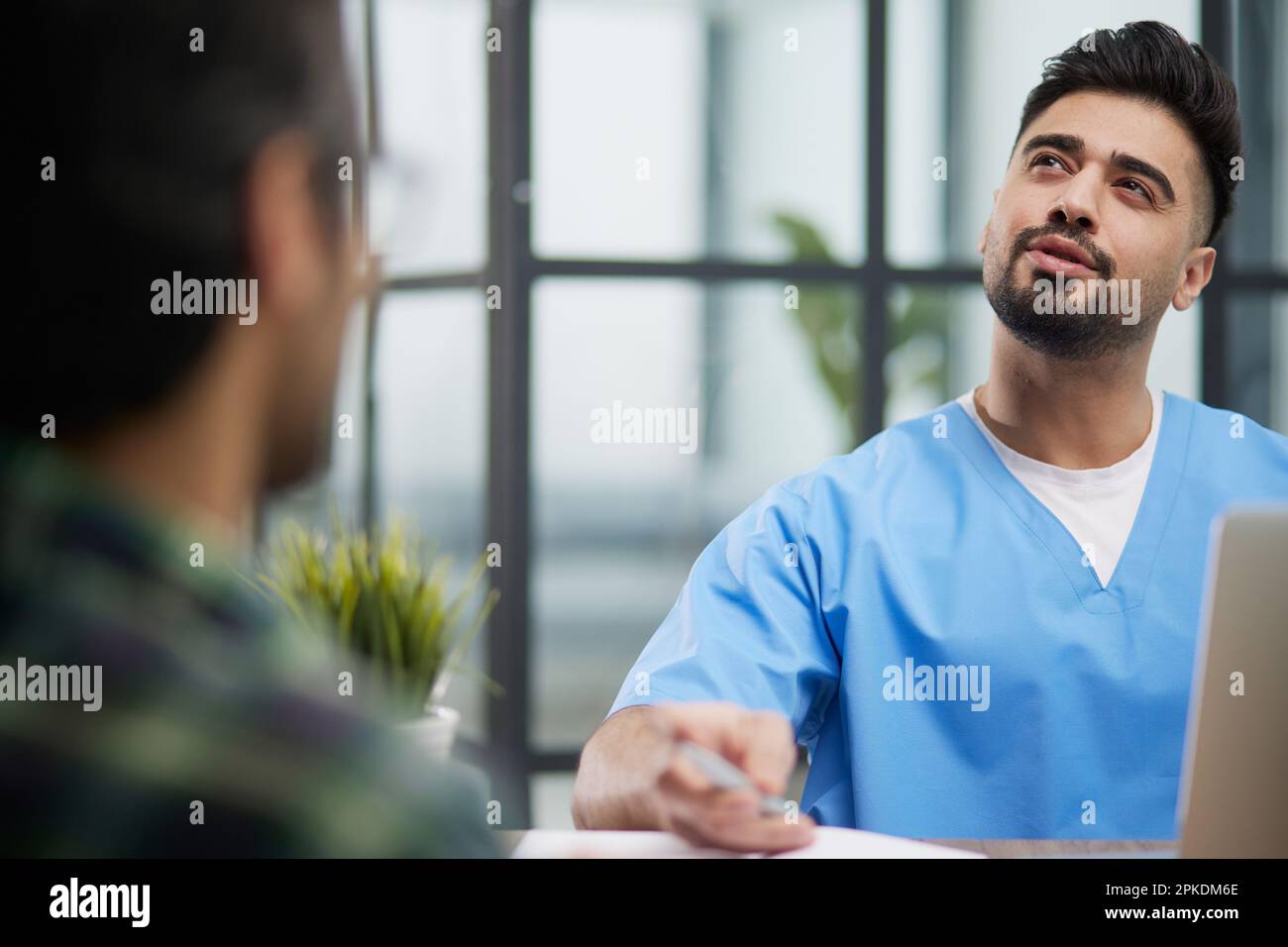 Professional male doctor receiving patient at his modern office Stock ...