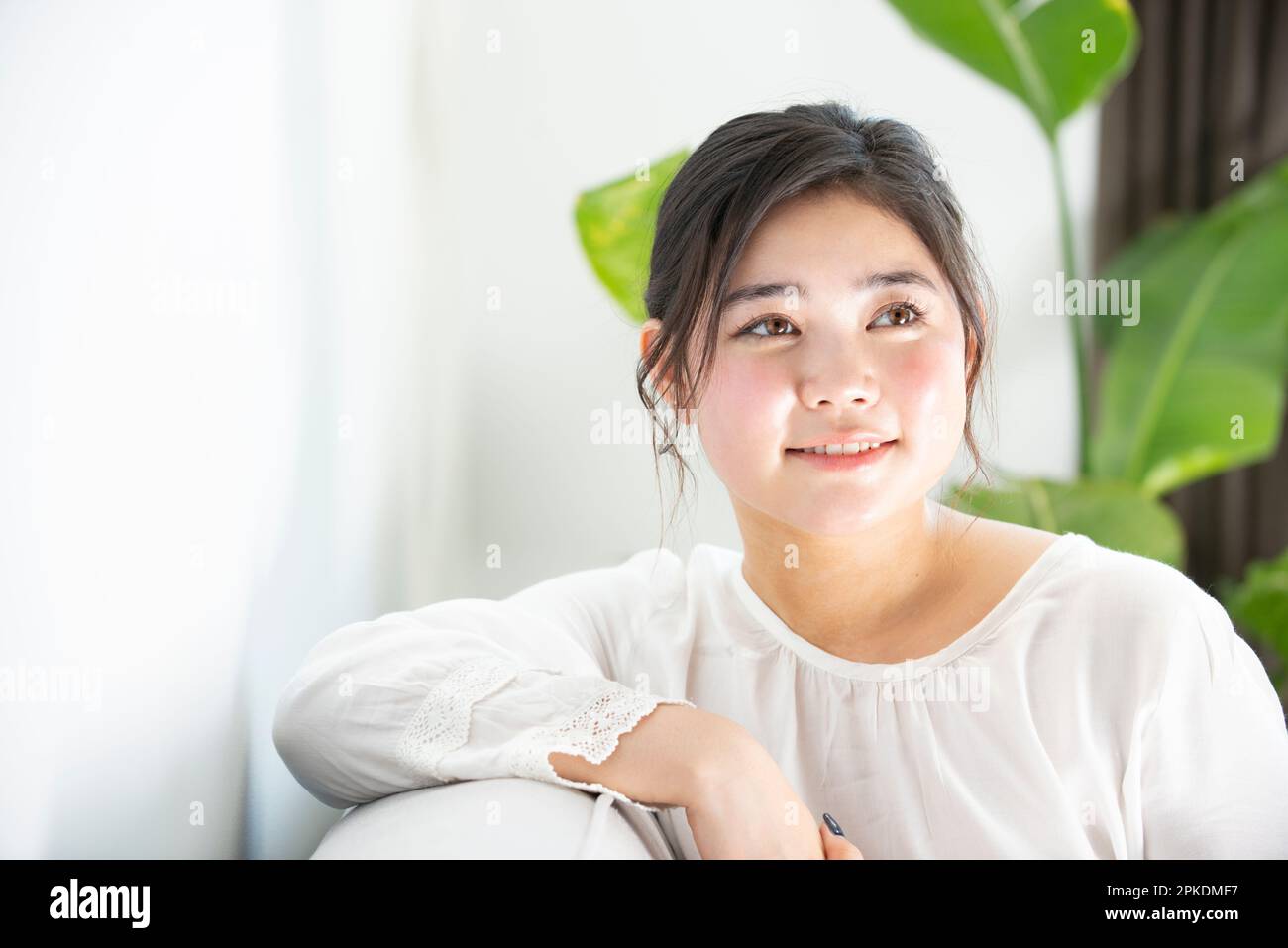 Woman relaxing indoors on couch hi-res stock photography and images - Alamy