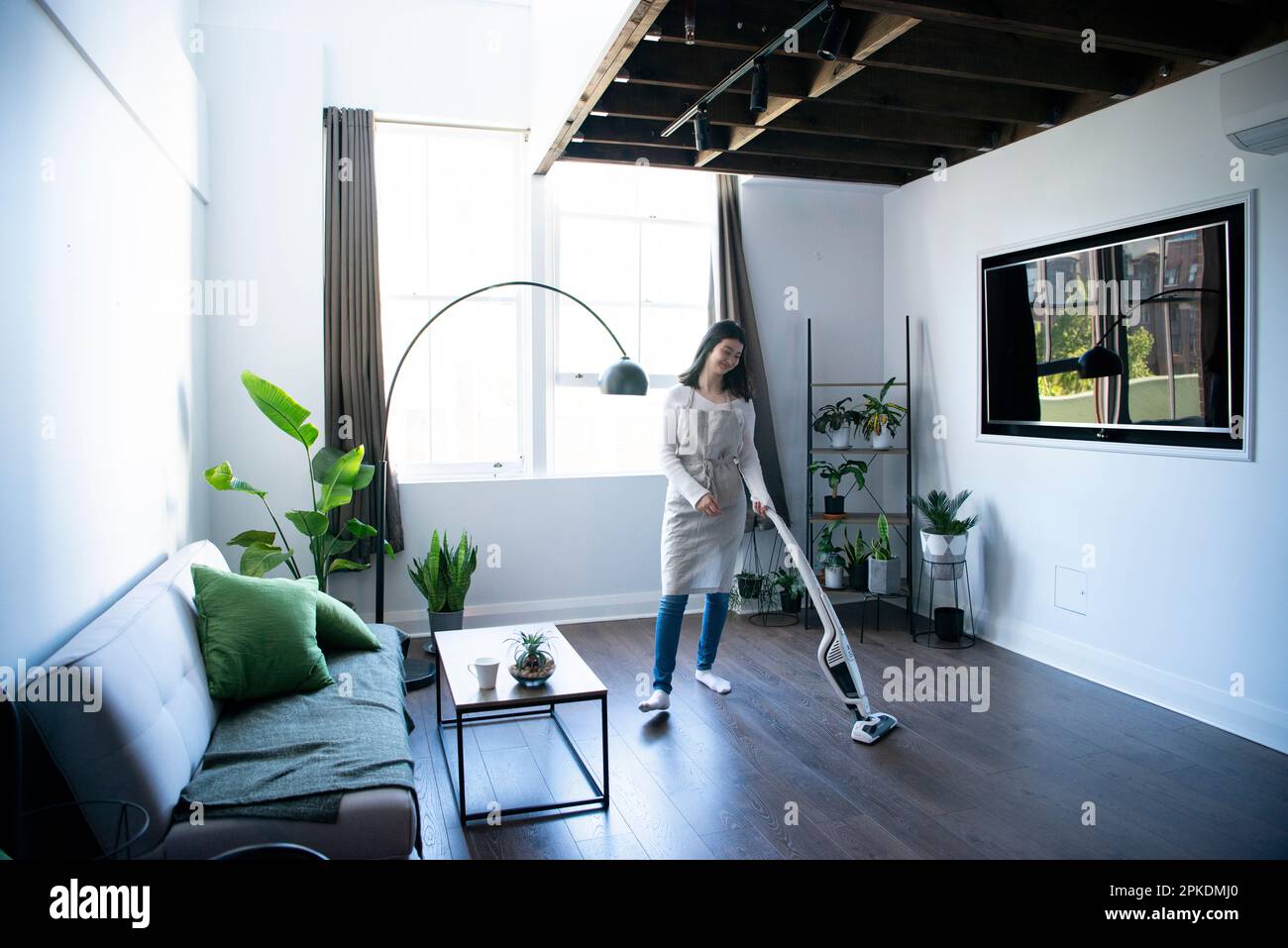 Woman vacuuming living room hi-res stock photography and images - Alamy