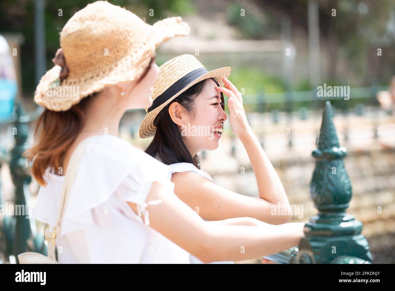 Two women laughing while looking into the distance Stock Photo - Alamy