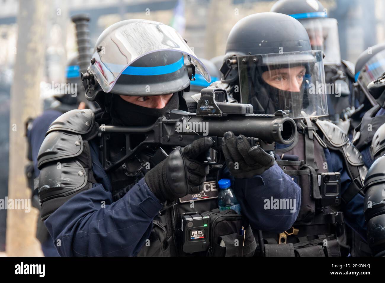 French police aiming with an LBD 40 mm blast ball riot gun, a kind of ...