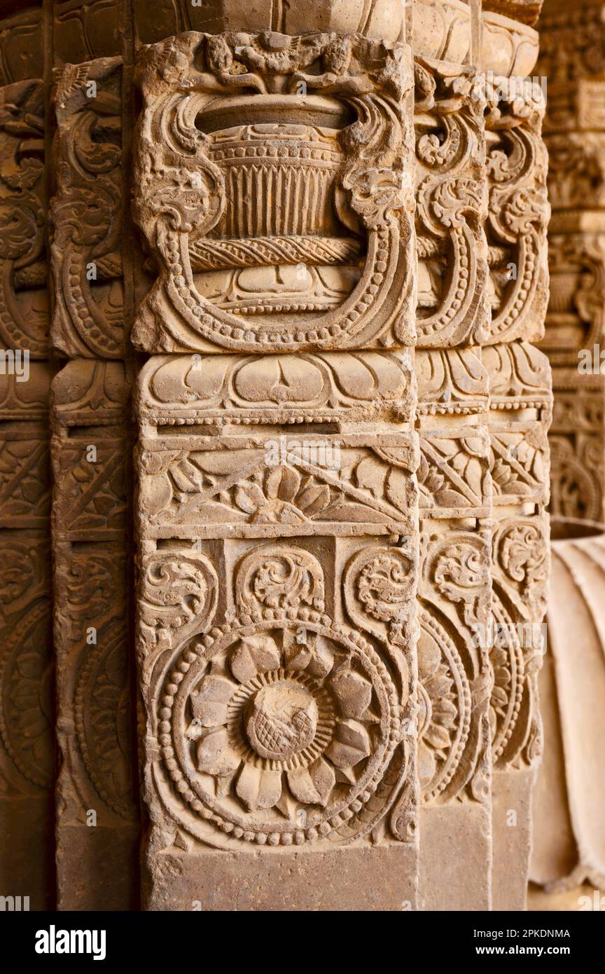 Carved stone pillars displayed in the corridor of Chand Baori, a deep ...