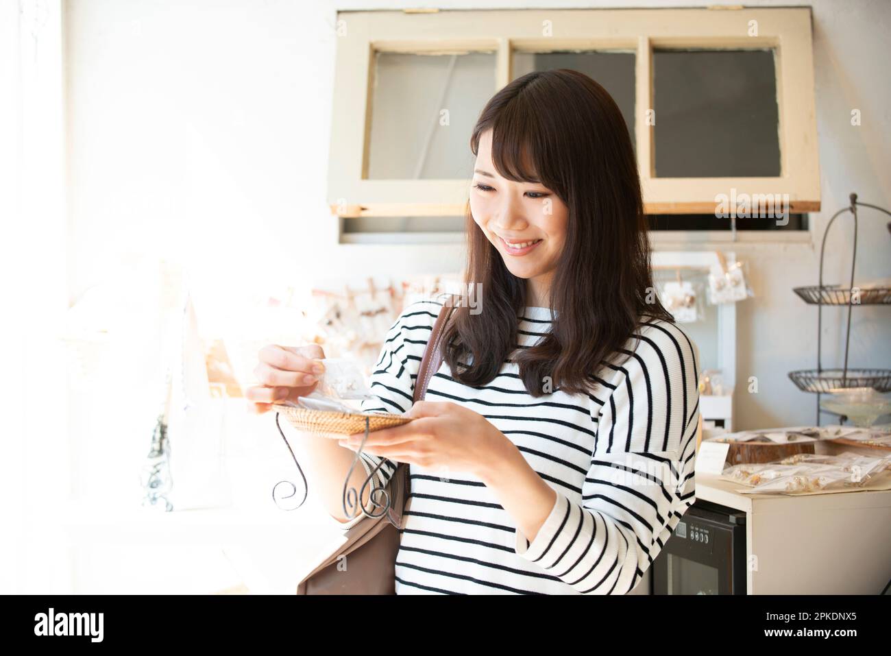 Woman selecting products at a grocery store Stock Photo - Alamy