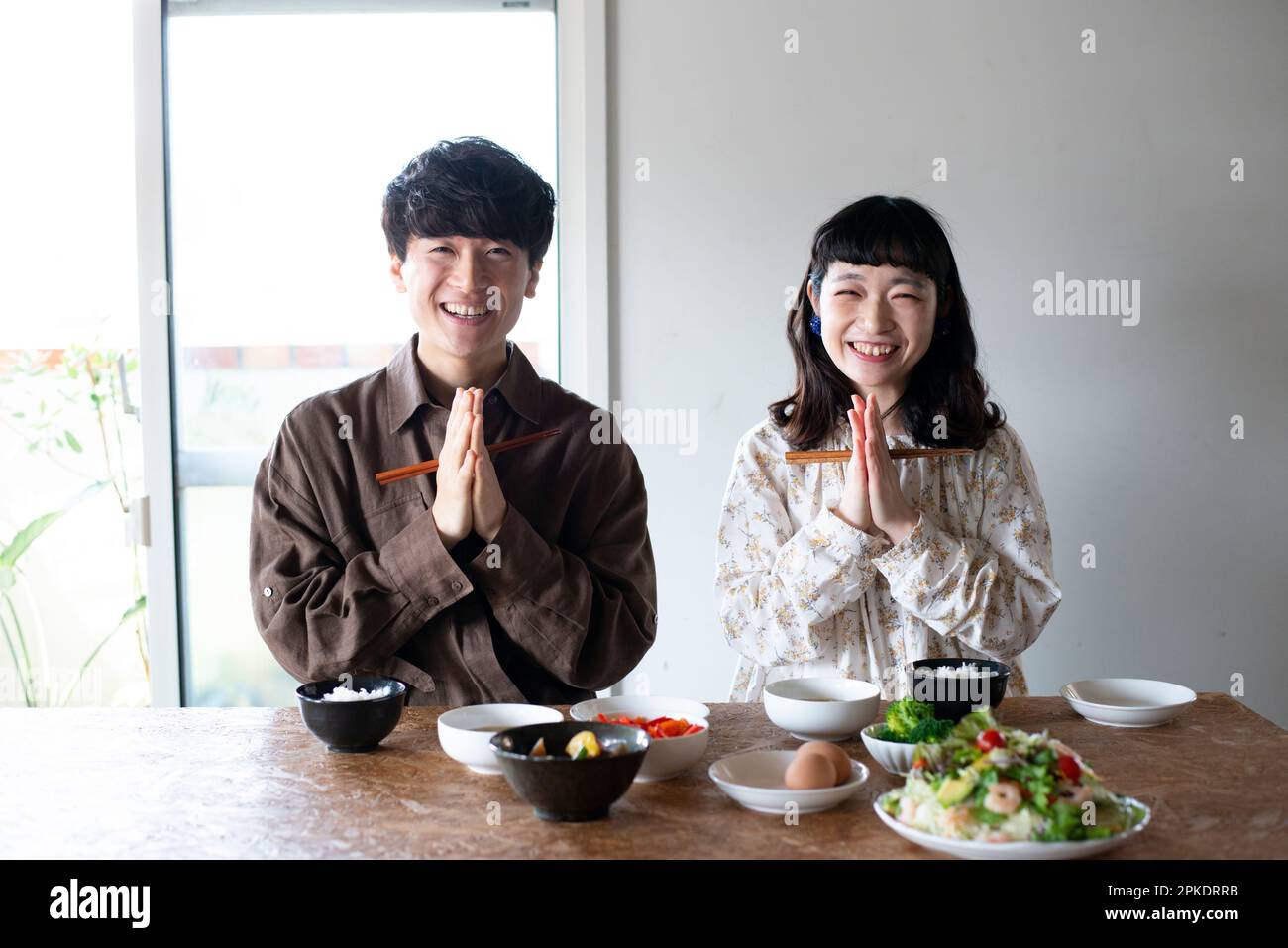 Couple having itadakimasu at home Stock Photo - Alamy