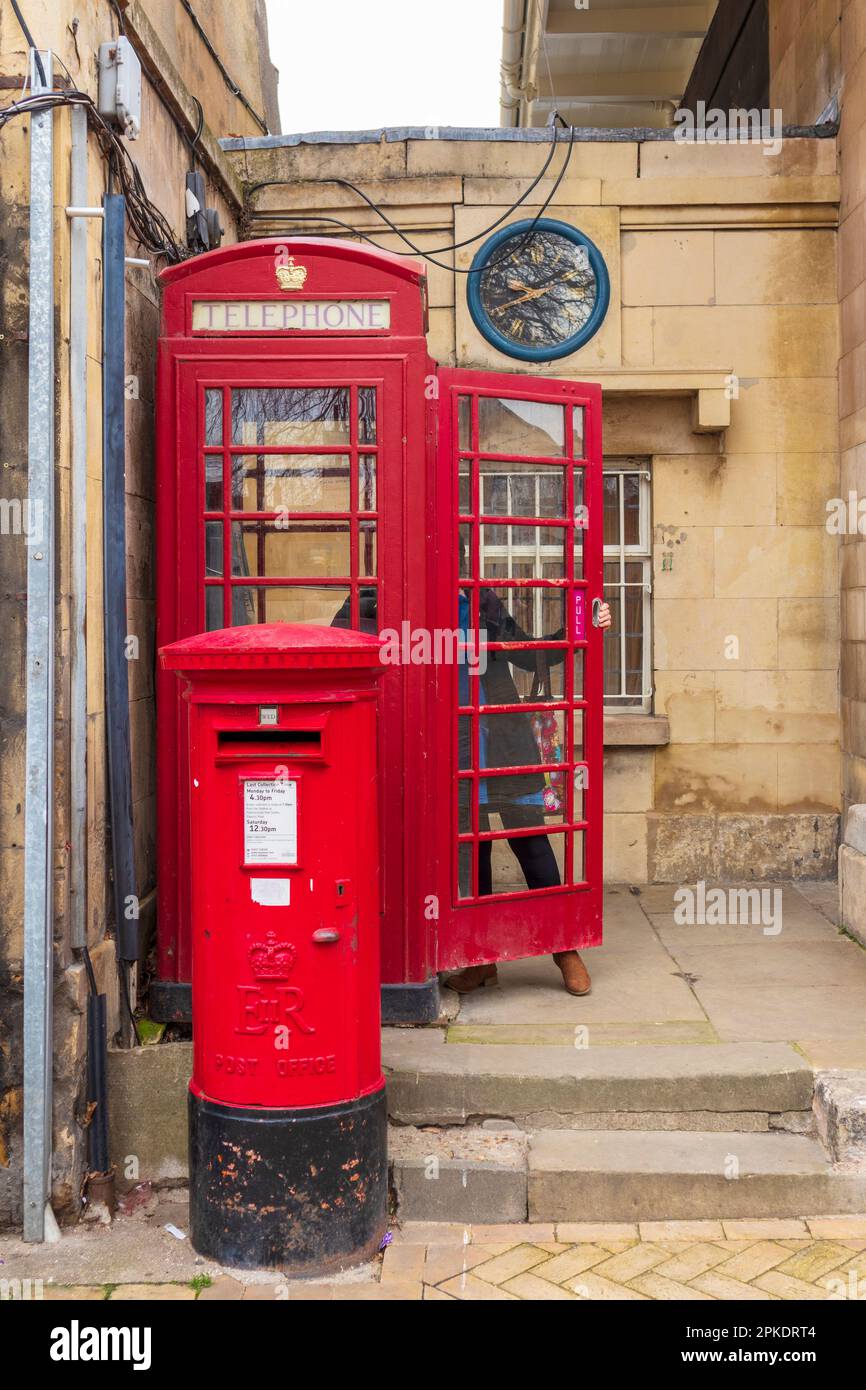 Person Entering Working Telephone Kiosk and Royal Mail Post Box in ...