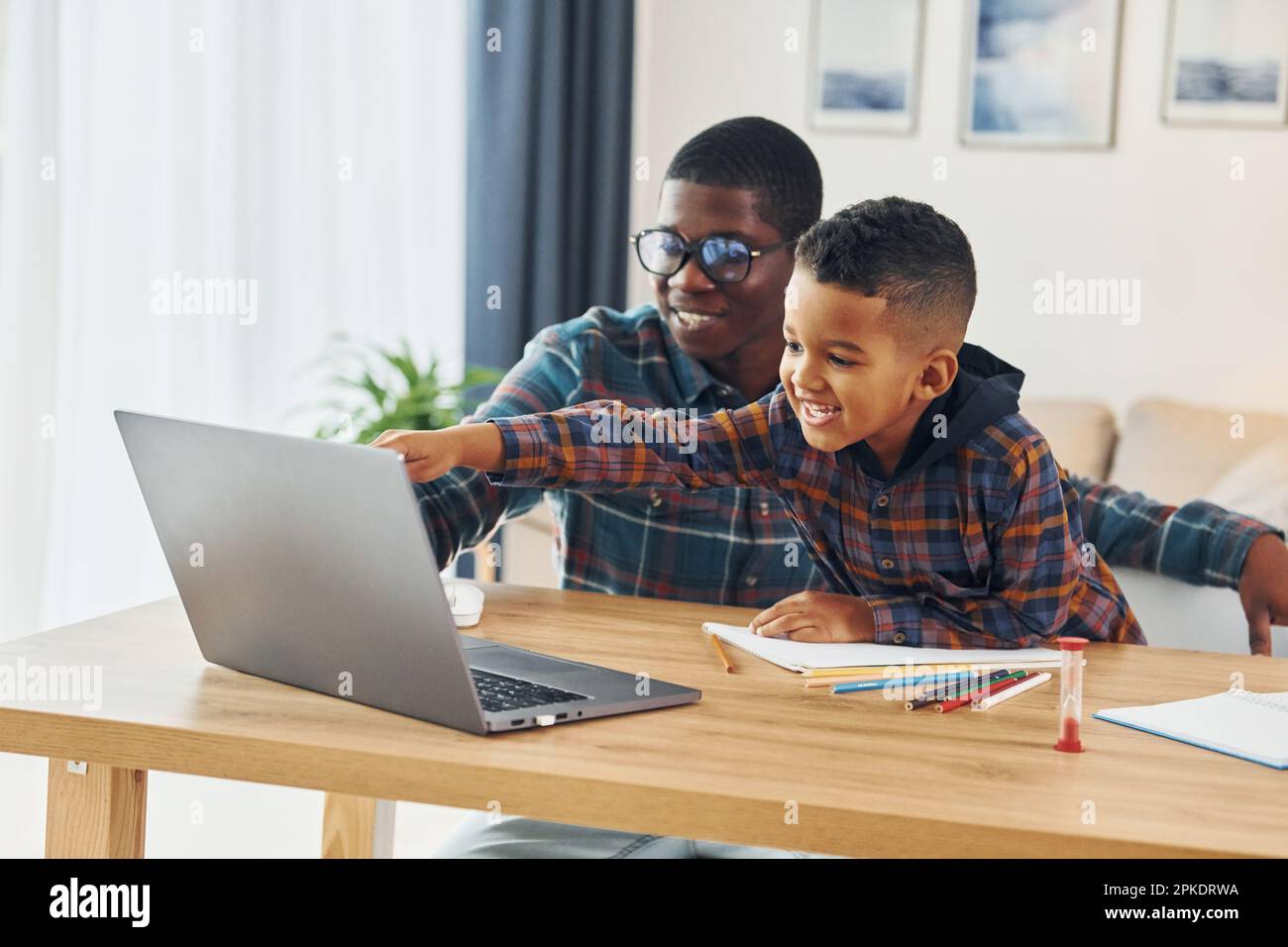 Using laptop. African american father with his young son at home Stock ...