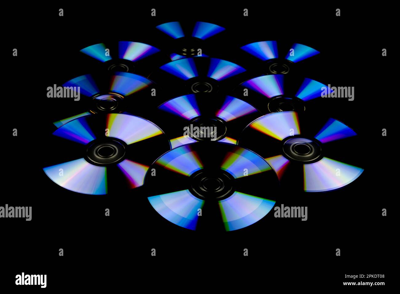 CD and DVD isolated on black background with colorful light reflections ...