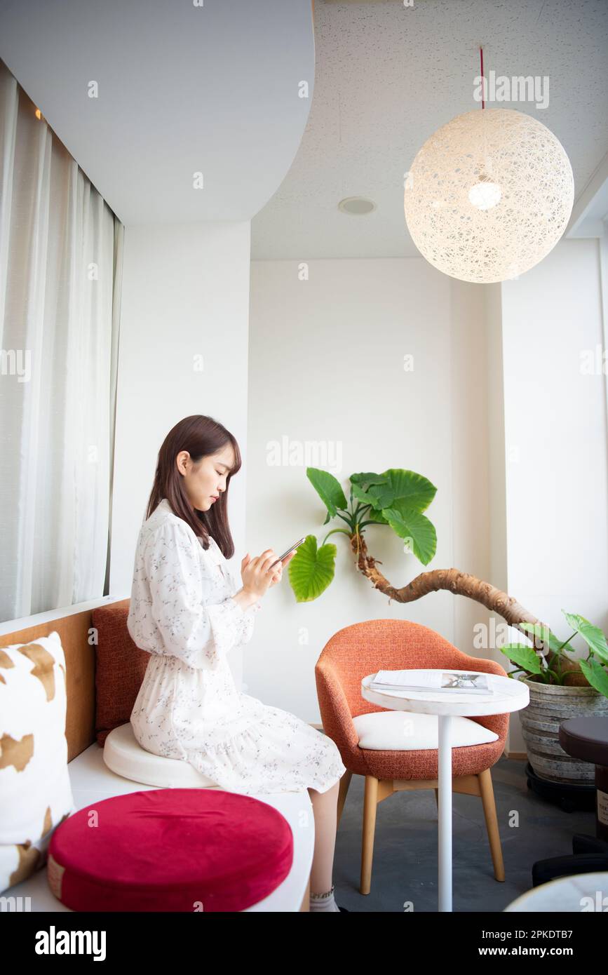 Woman reading a magazine in the waiting room Stock Photo - Alamy