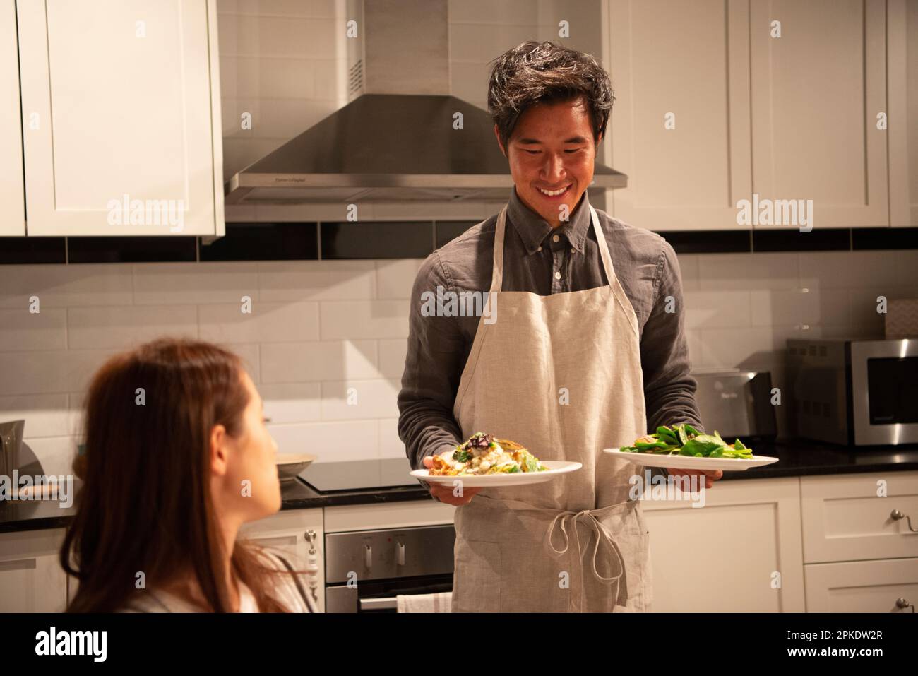 Man carrying dishes Stock Photo - Alamy