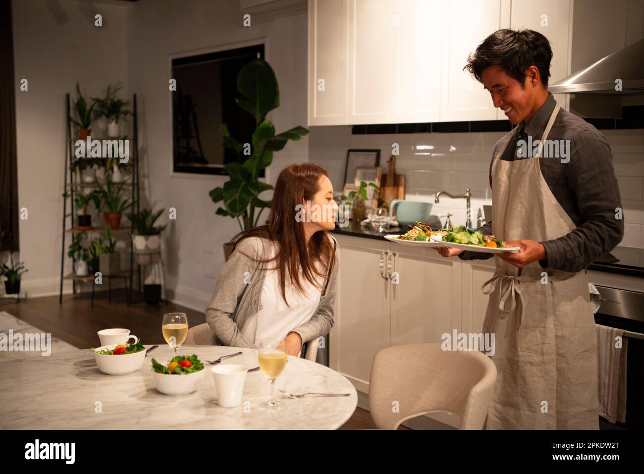 Man carrying food in the kitchen Stock Photo - Alamy