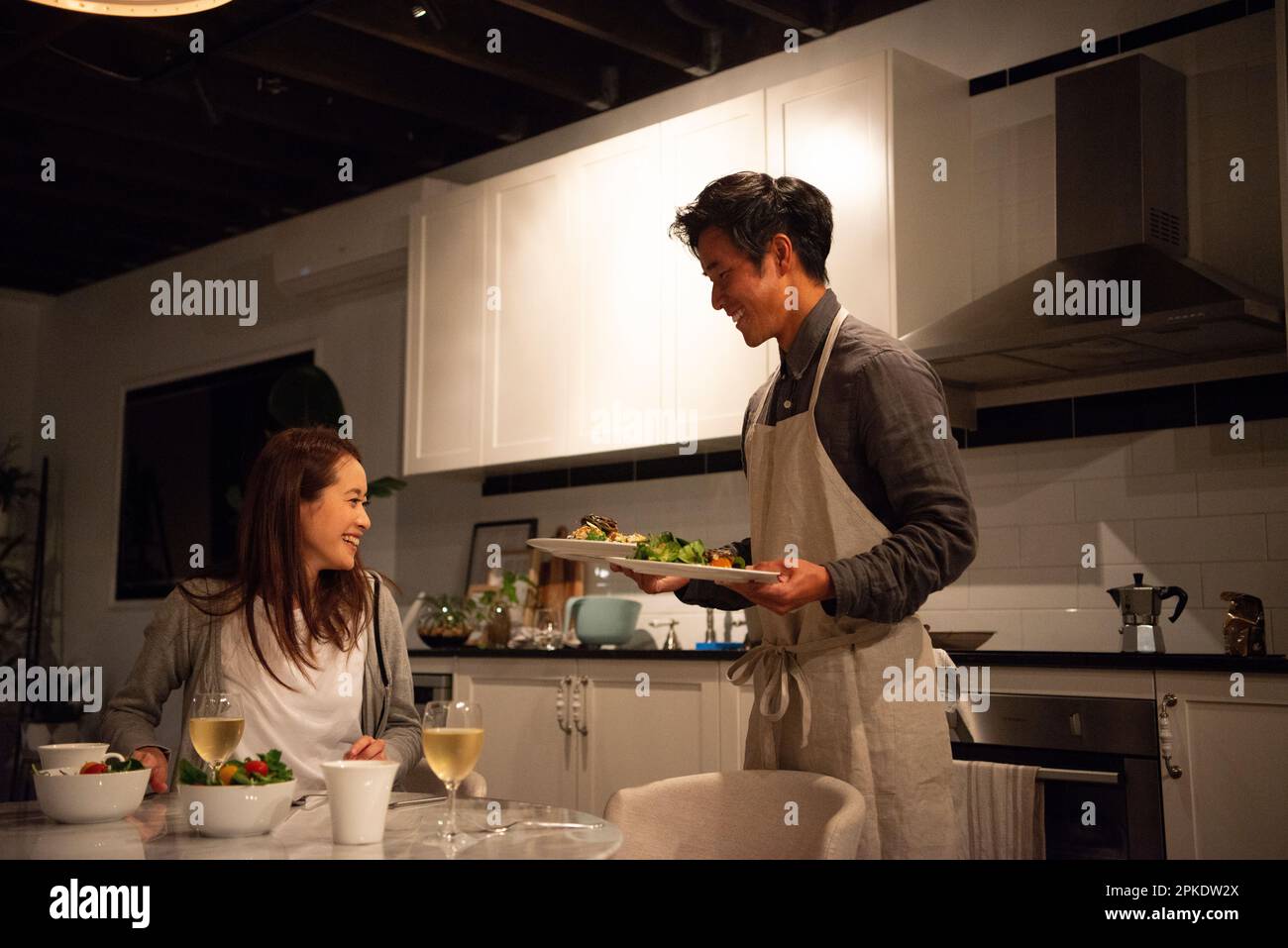 Man carrying food in the kitchen Stock Photo - Alamy