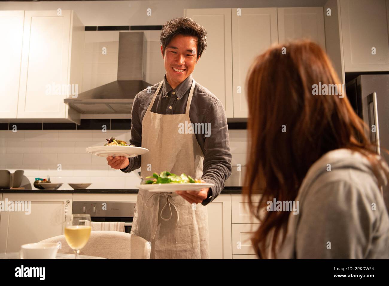 Man carrying food in the kitchen Stock Photo - Alamy