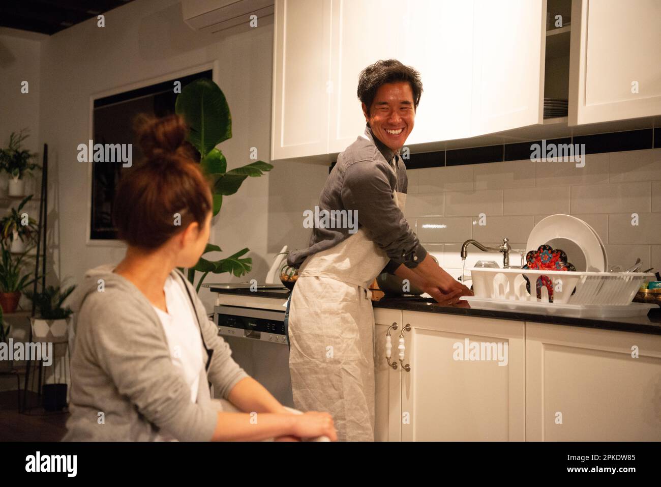 Man washing dishes in kitchen Stock Photo - Alamy