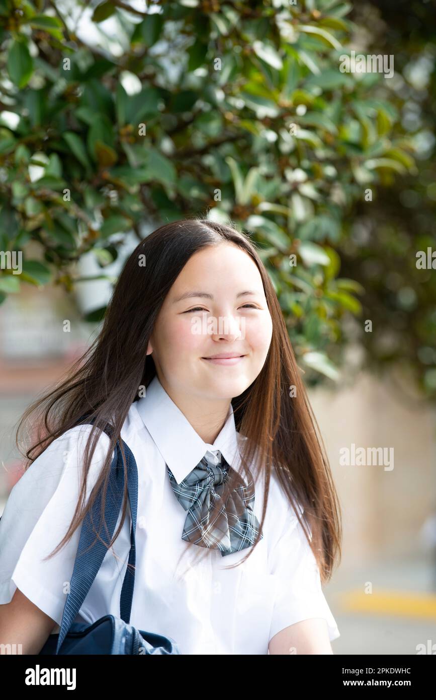 Female student in school uniform smiling Stock Photo - Alamy
