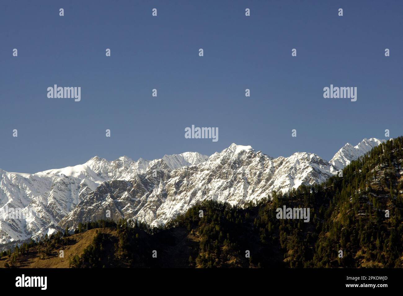 Snow covered Himalayan mountains peaks near village Sarahan state ...