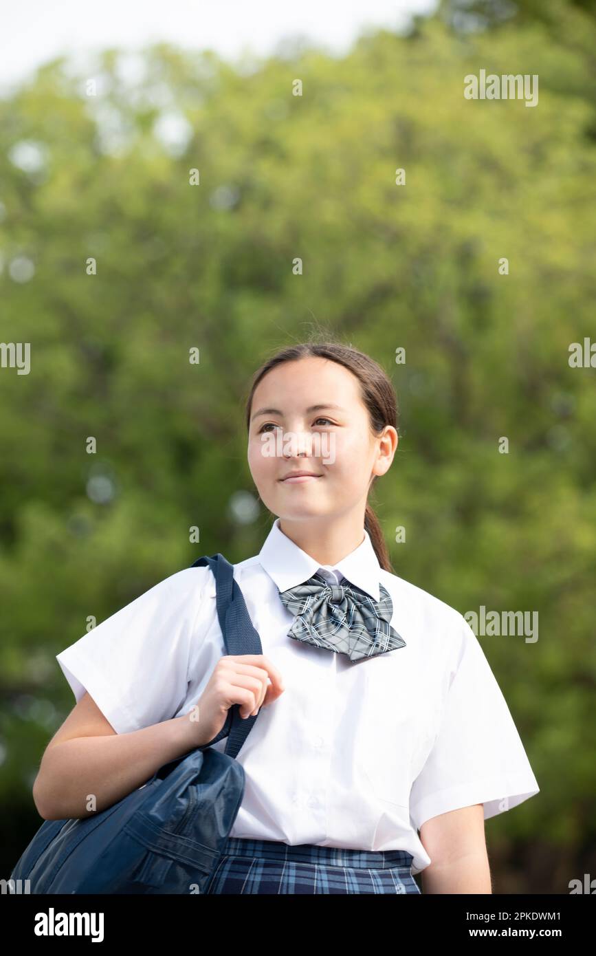 Female student in school uniform looking into the distance Stock Photo ...