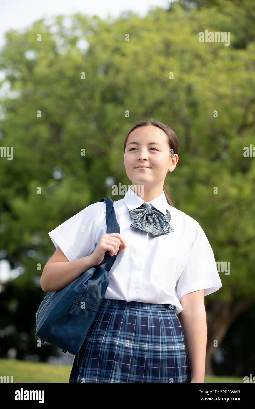 Female student in school uniform looking into the distance Stock Photo ...