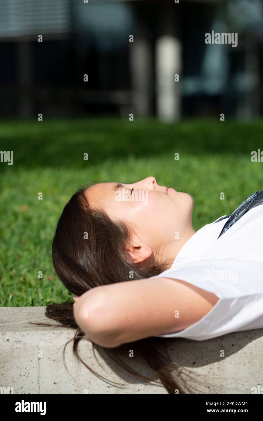Female student in school uniform lying down Stock Photo - Alamy