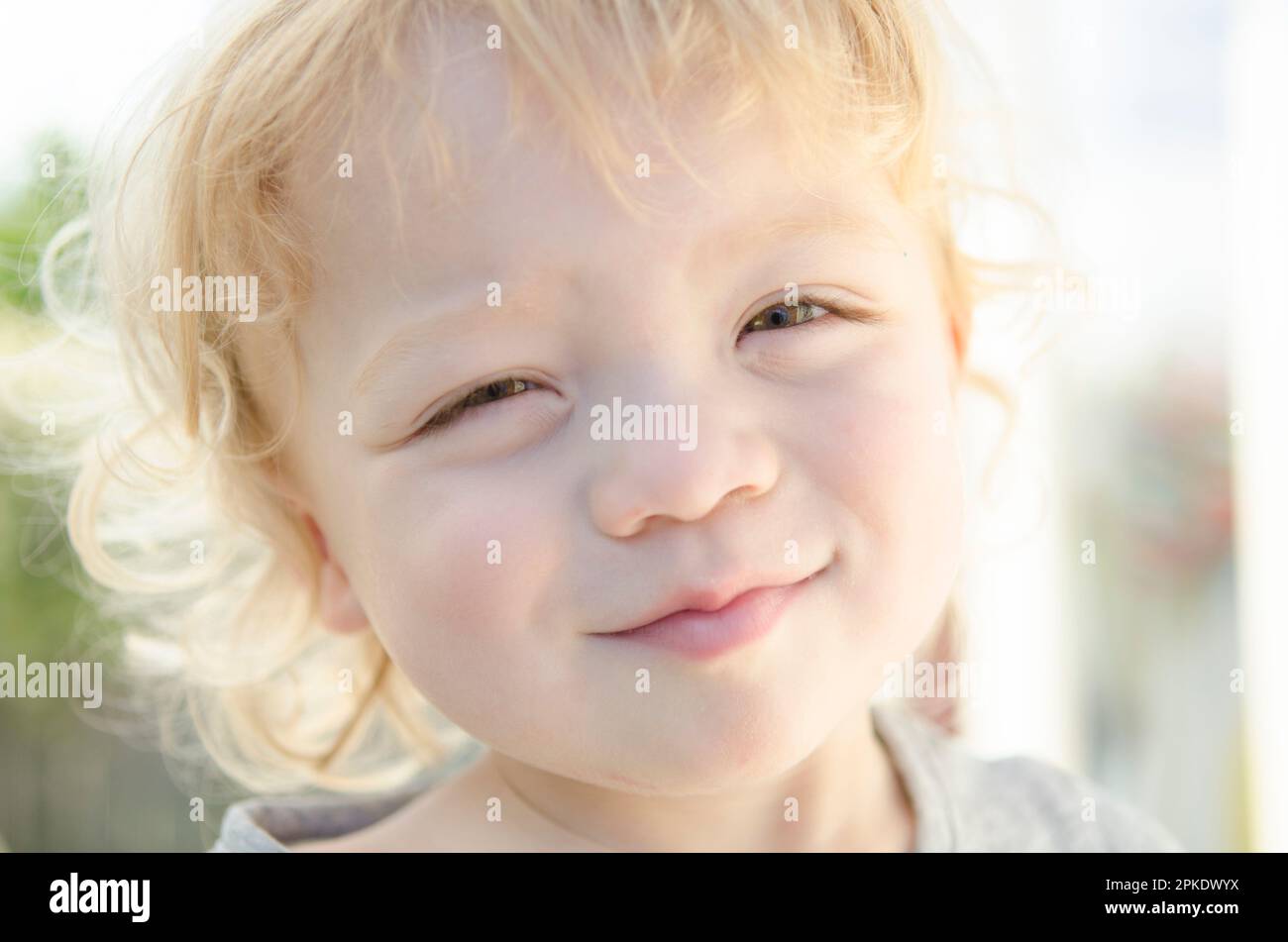 Boy looking at us and smiling Stock Photo - Alamy
