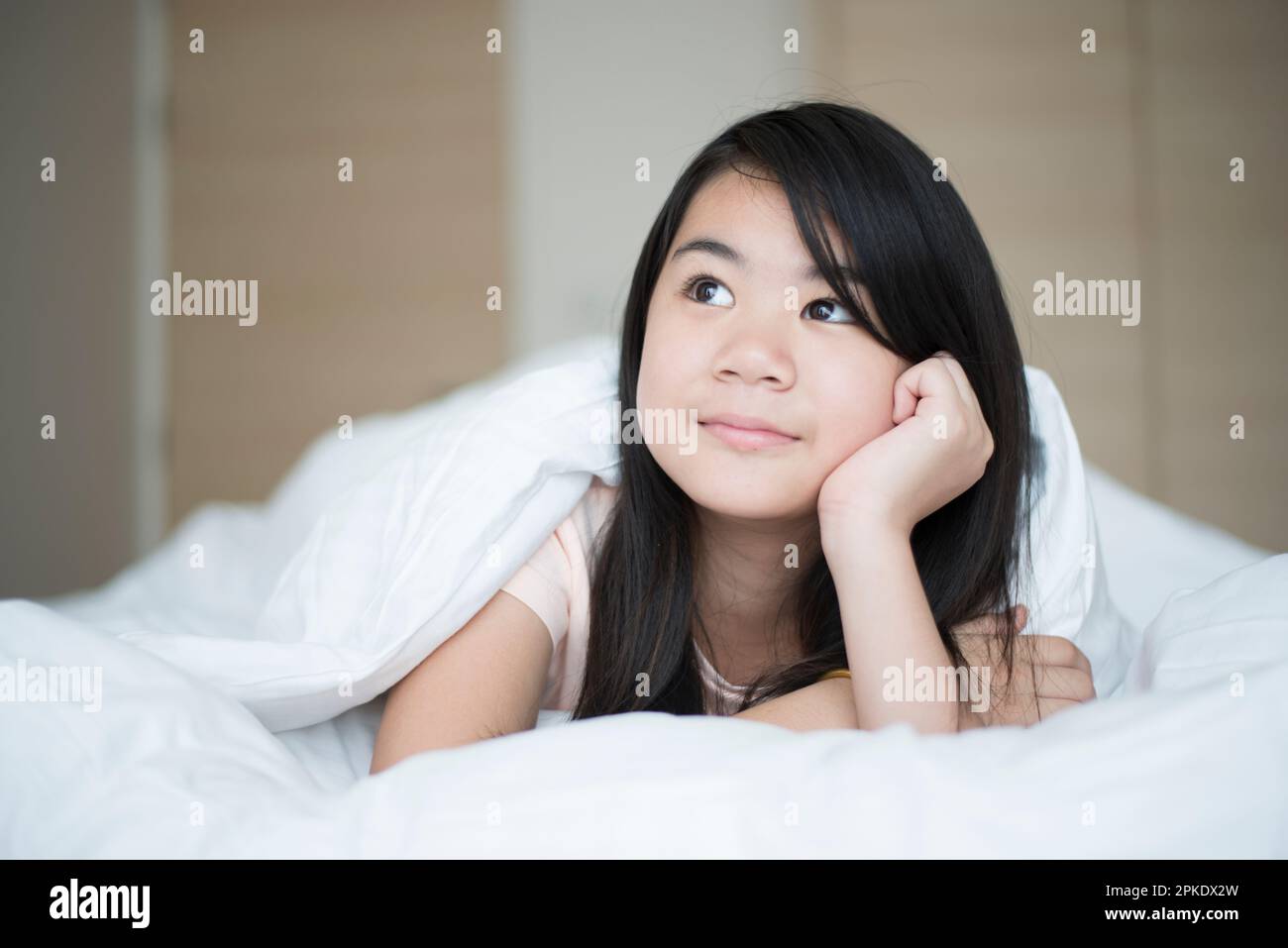 Girl Lying in Bed Stock Photo - Alamy