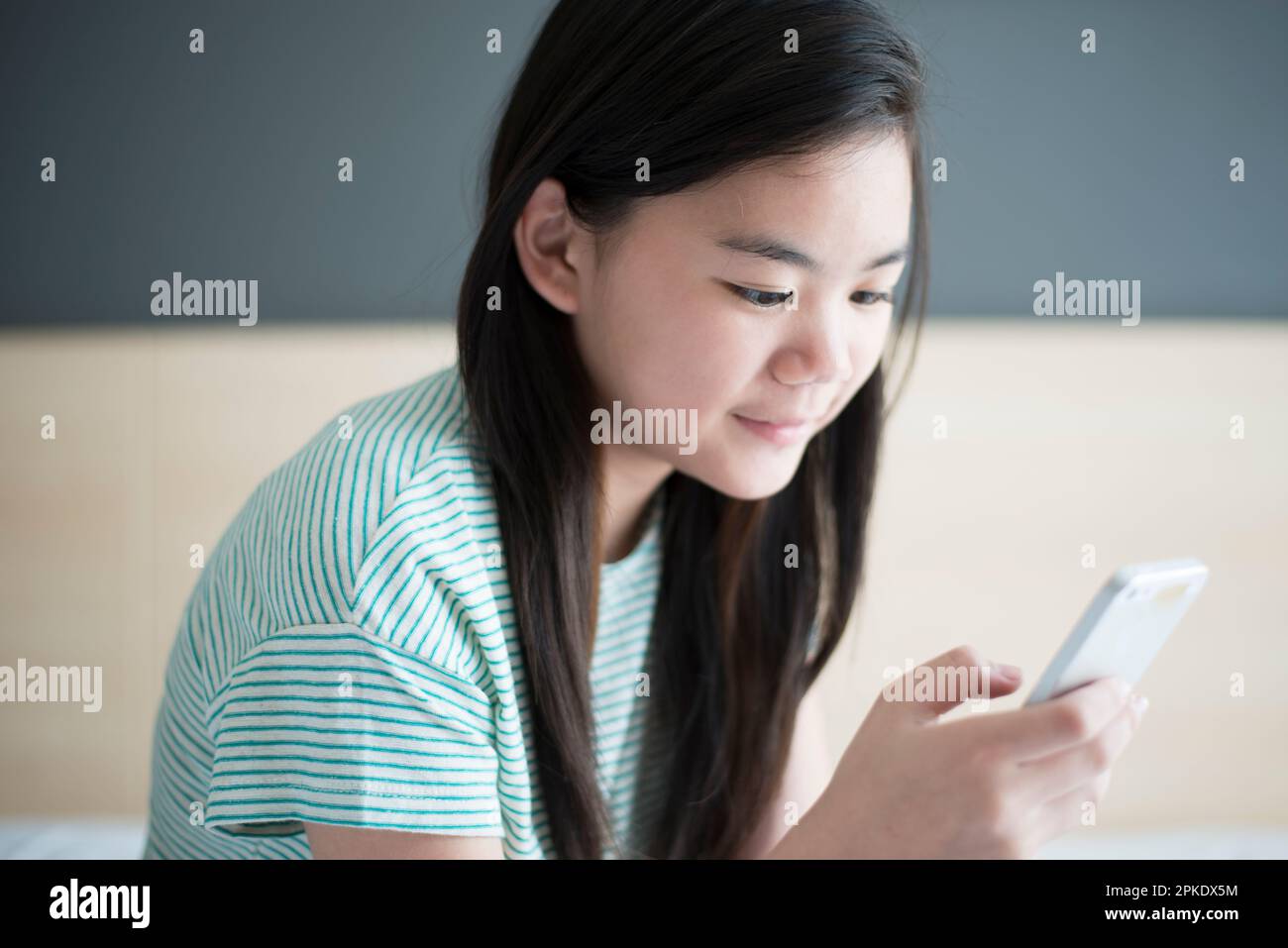 Girl looking at her phone Stock Photo - Alamy
