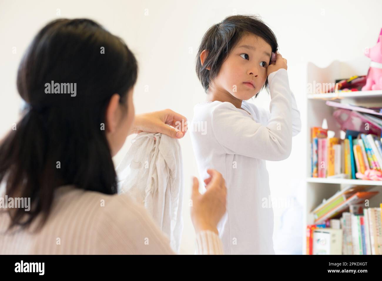 Girl and mother getting dressed Stock Photo - Alamy
