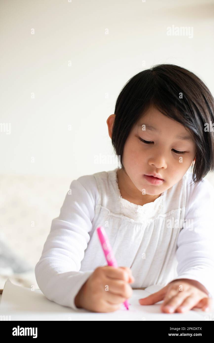 Girl drawing in the living room Stock Photo - Alamy