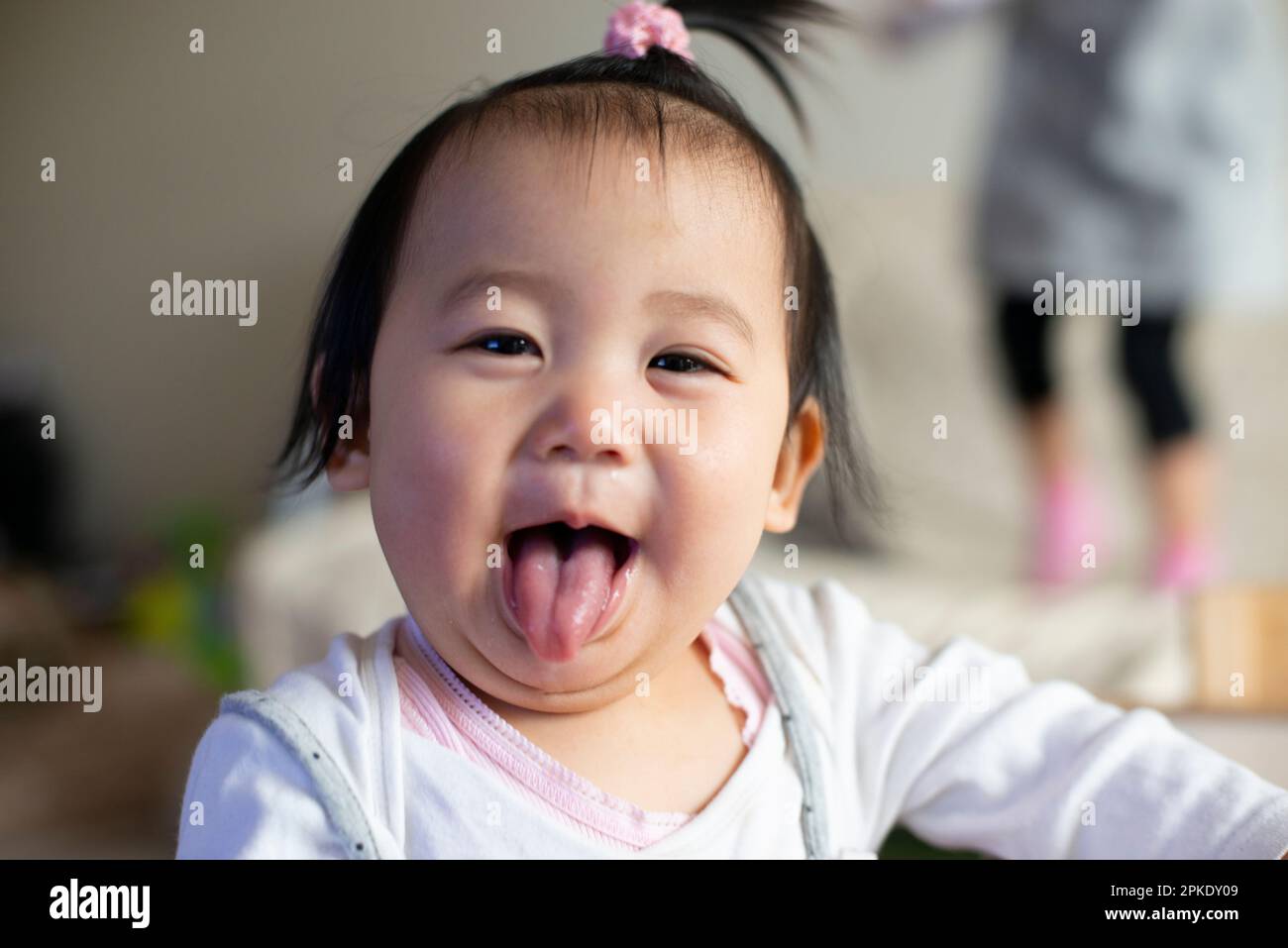 Baby laughing in living room Stock Photo - Alamy