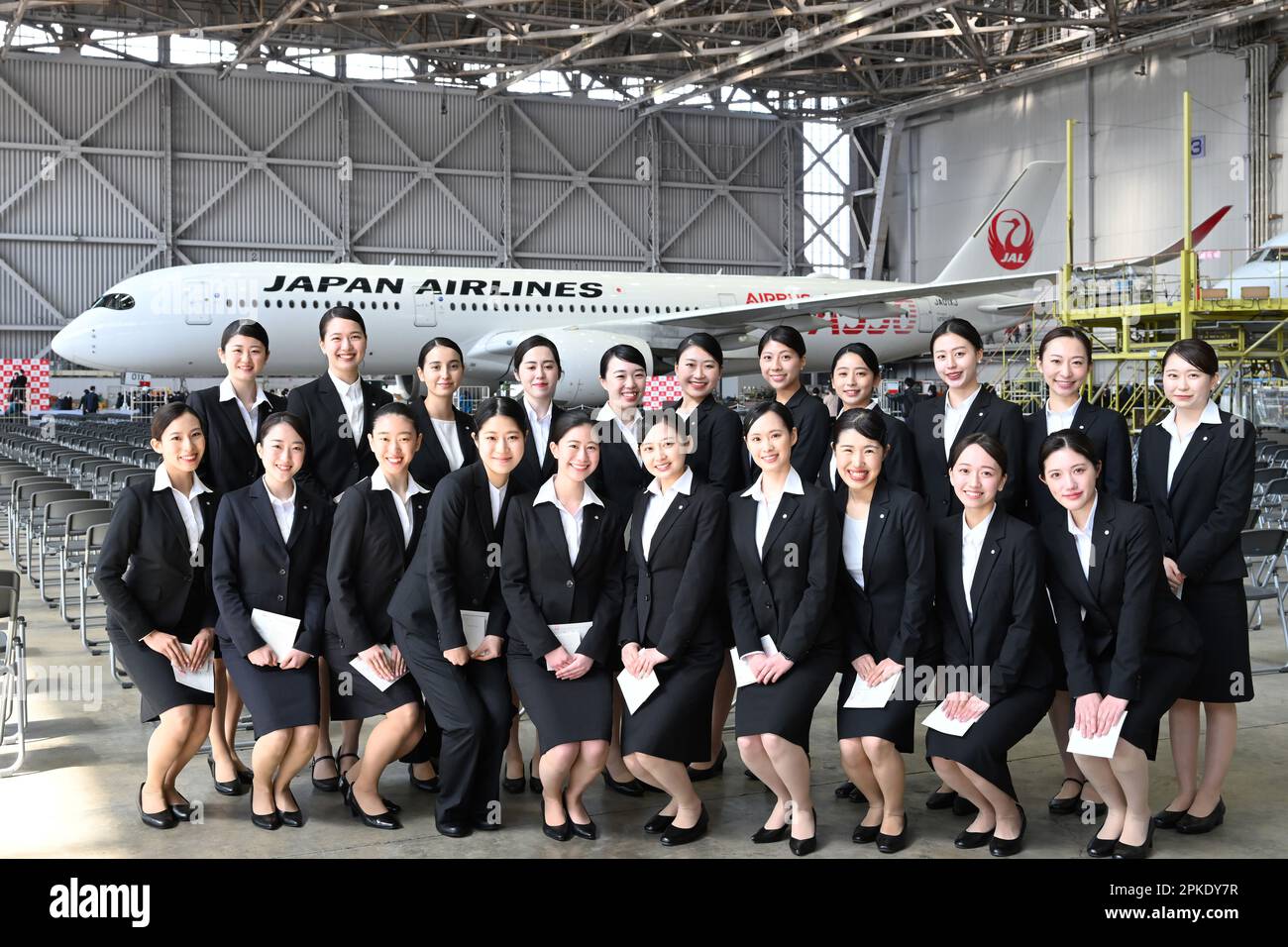 New cabin crew members pose for a commemorative photo after JAL's ...