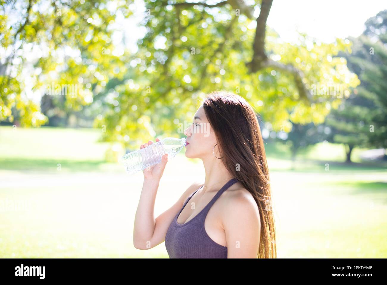 Fitness woman drinking water outdoors hi-res stock photography and ...