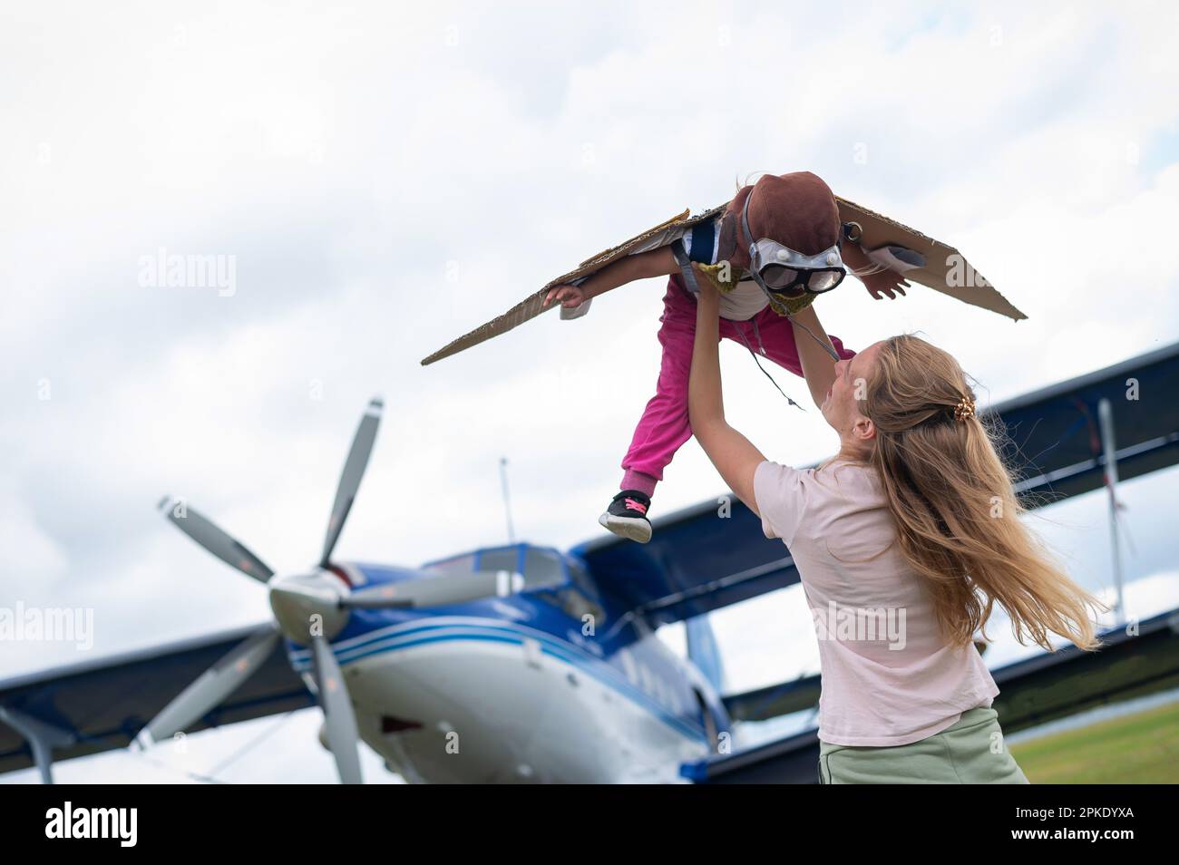 A loving Caucasian woman is playing with her little daughter in ...
