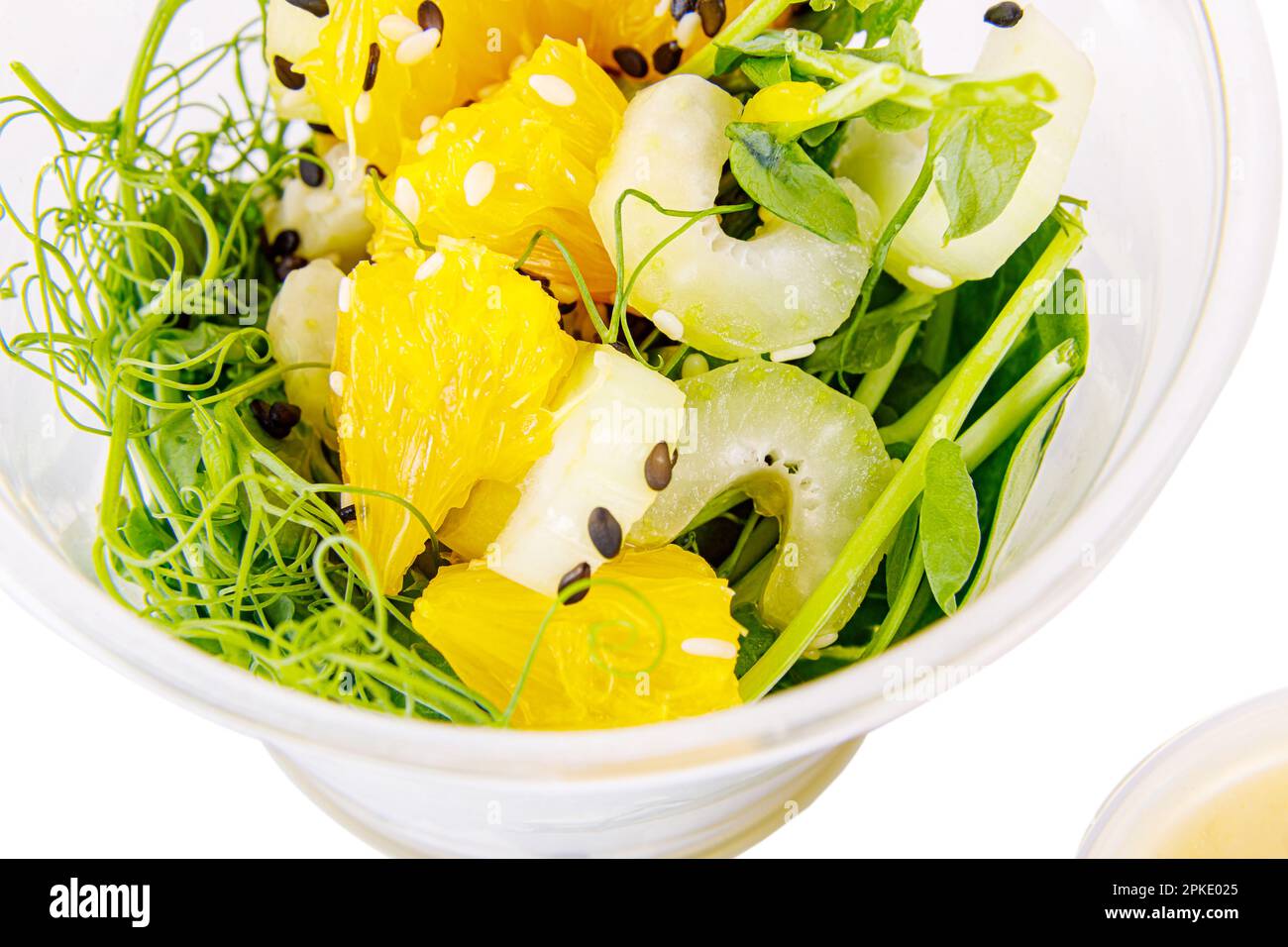Salad with microgreens peas, spinach, celery, orange, sesame seeds and ...