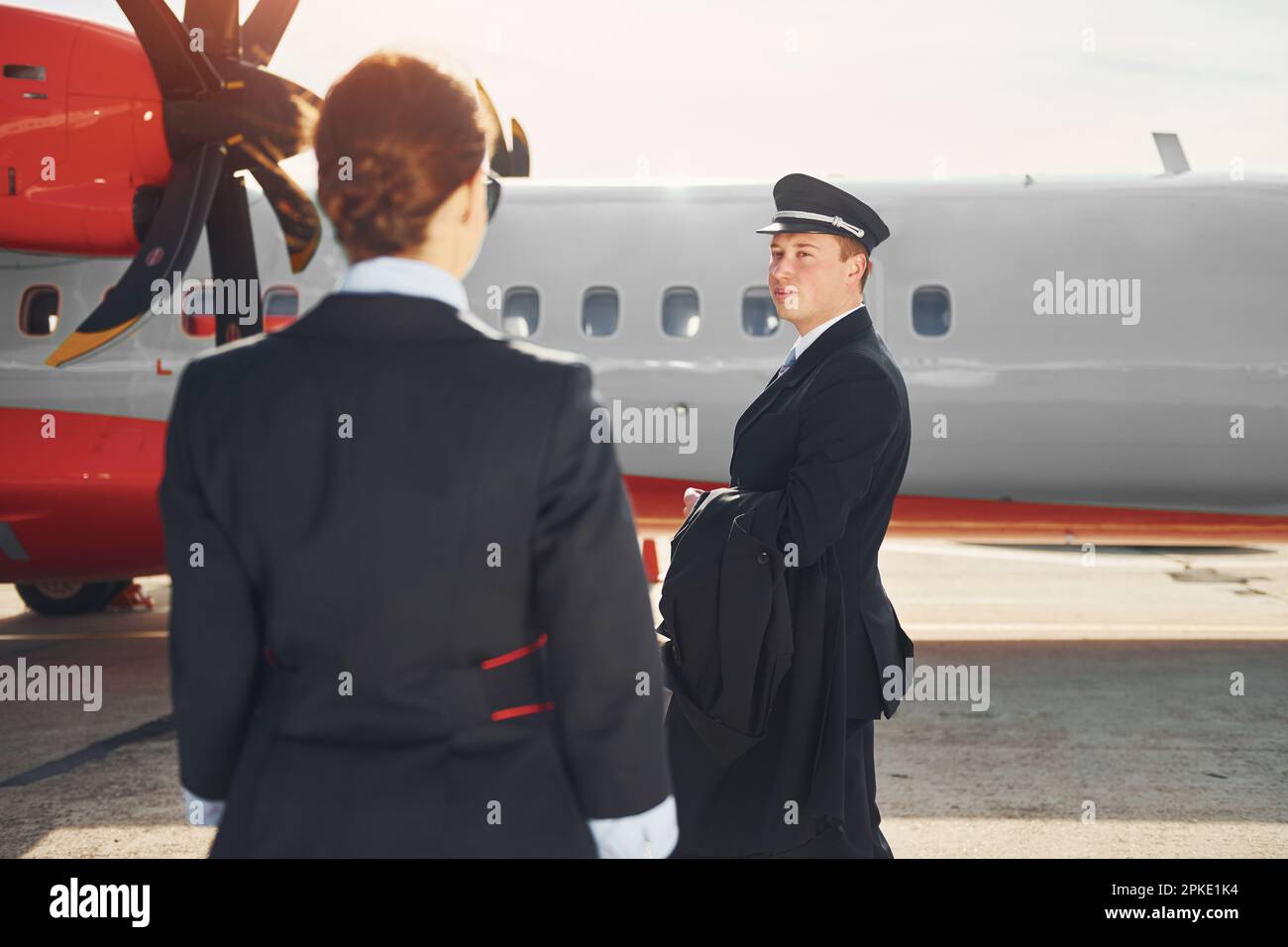 Pilot and stewardess. Crew of airport and plane workers in formal ...