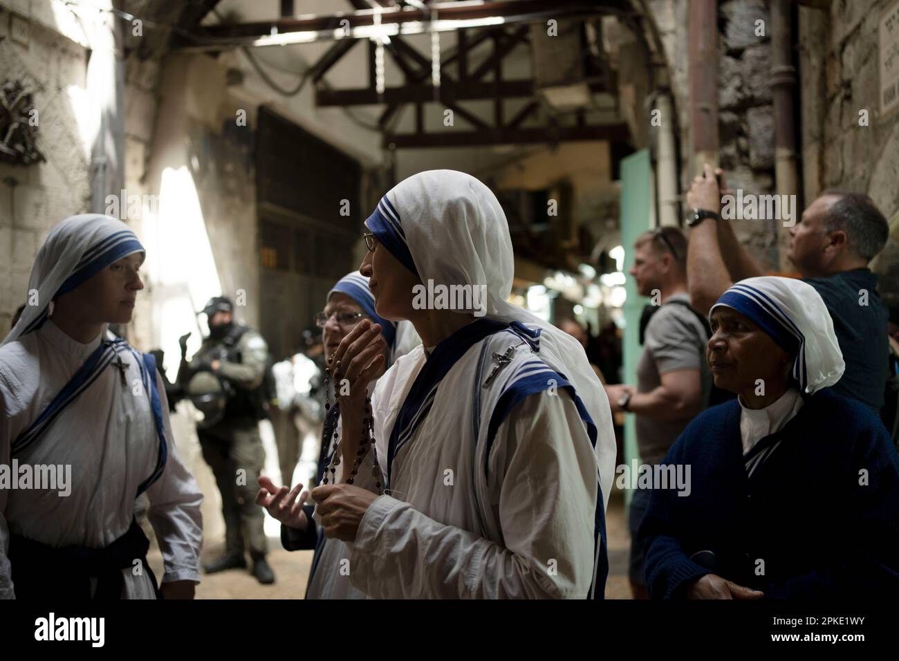 Nuns pause in a procession along the Via Dolorosa, a route that is ...