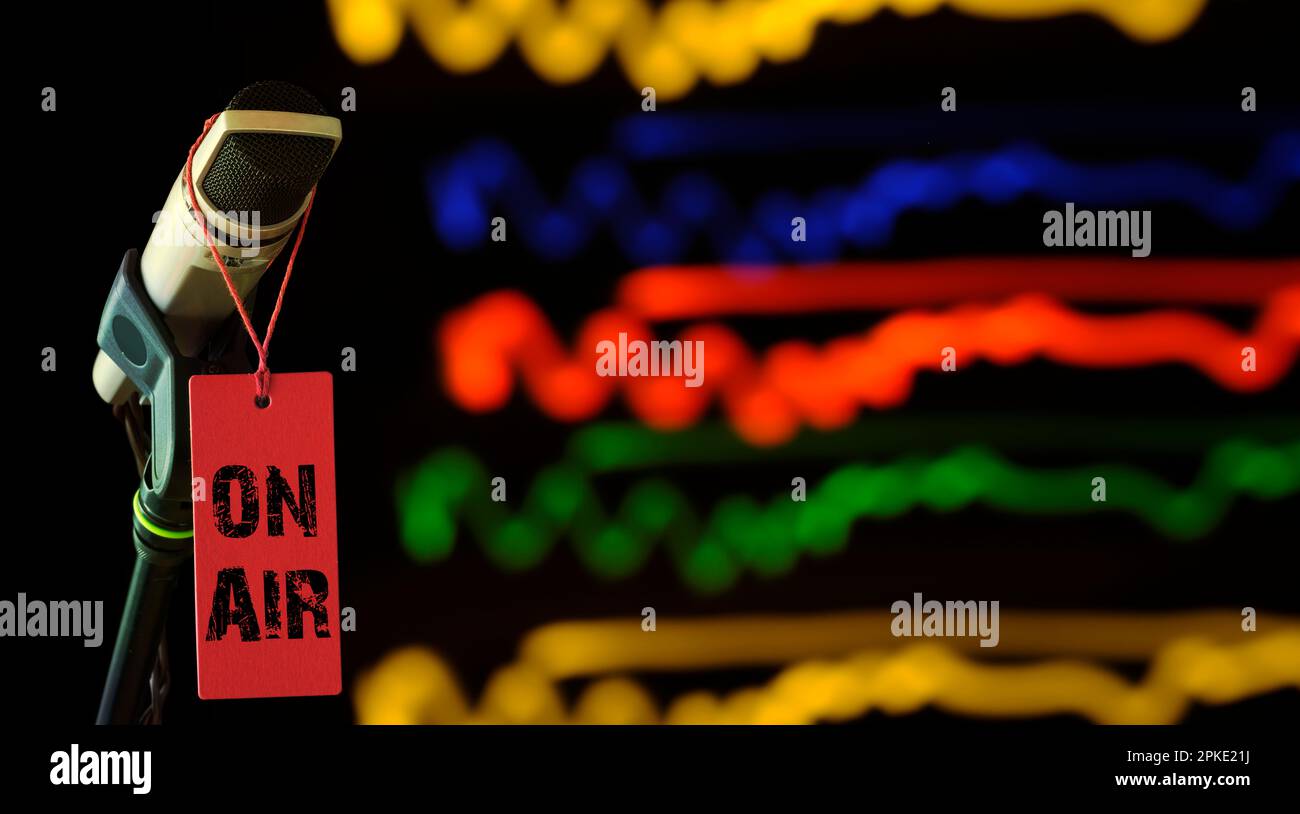 Podcasting concept, vintage recording microphone and on air sign on ...