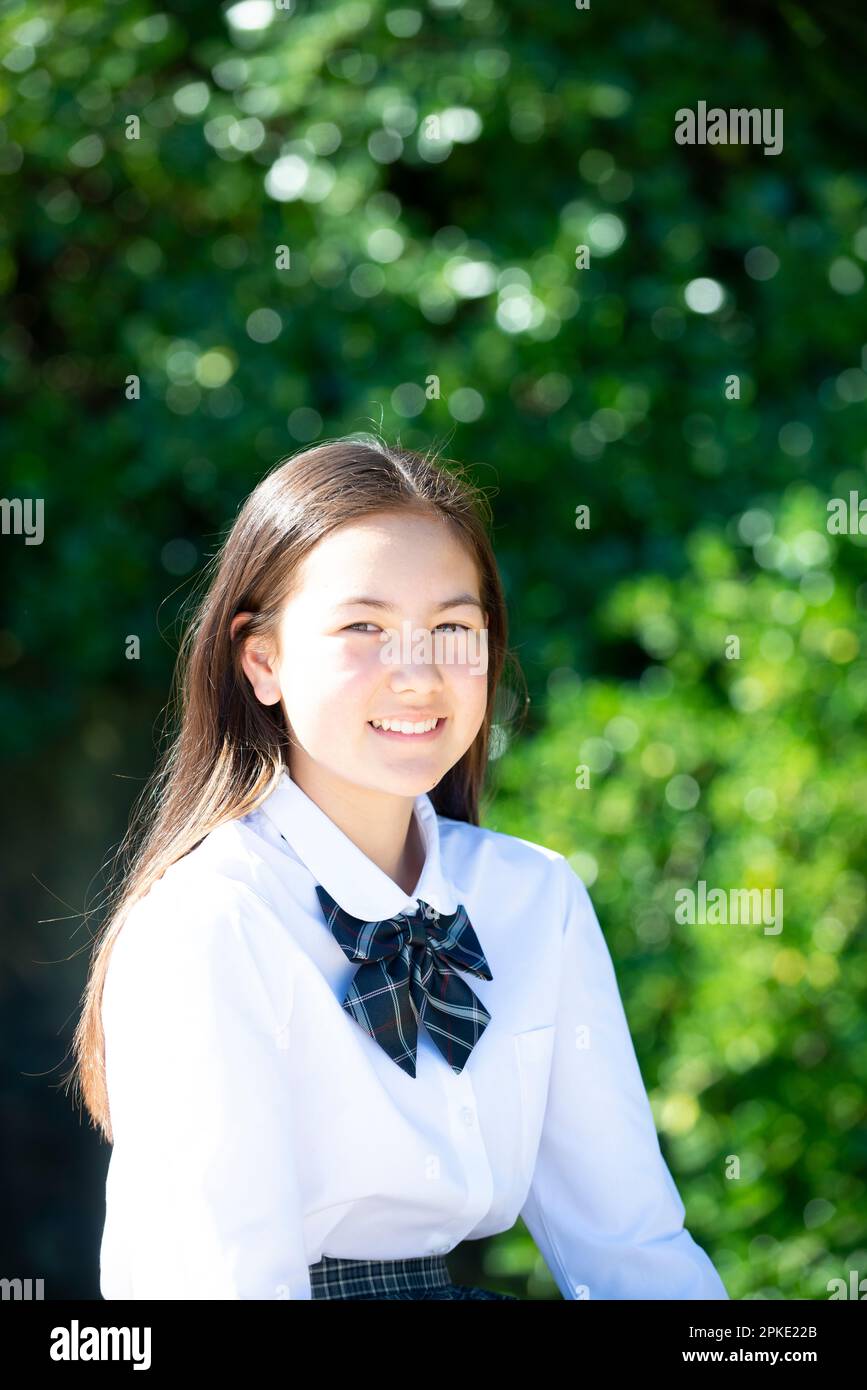 Female student in uniform smiling Stock Photo - Alamy