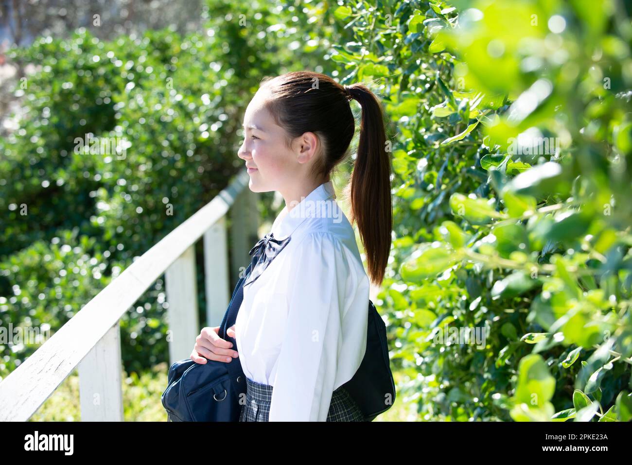 Female student in school uniform looking into the distance Stock Photo ...