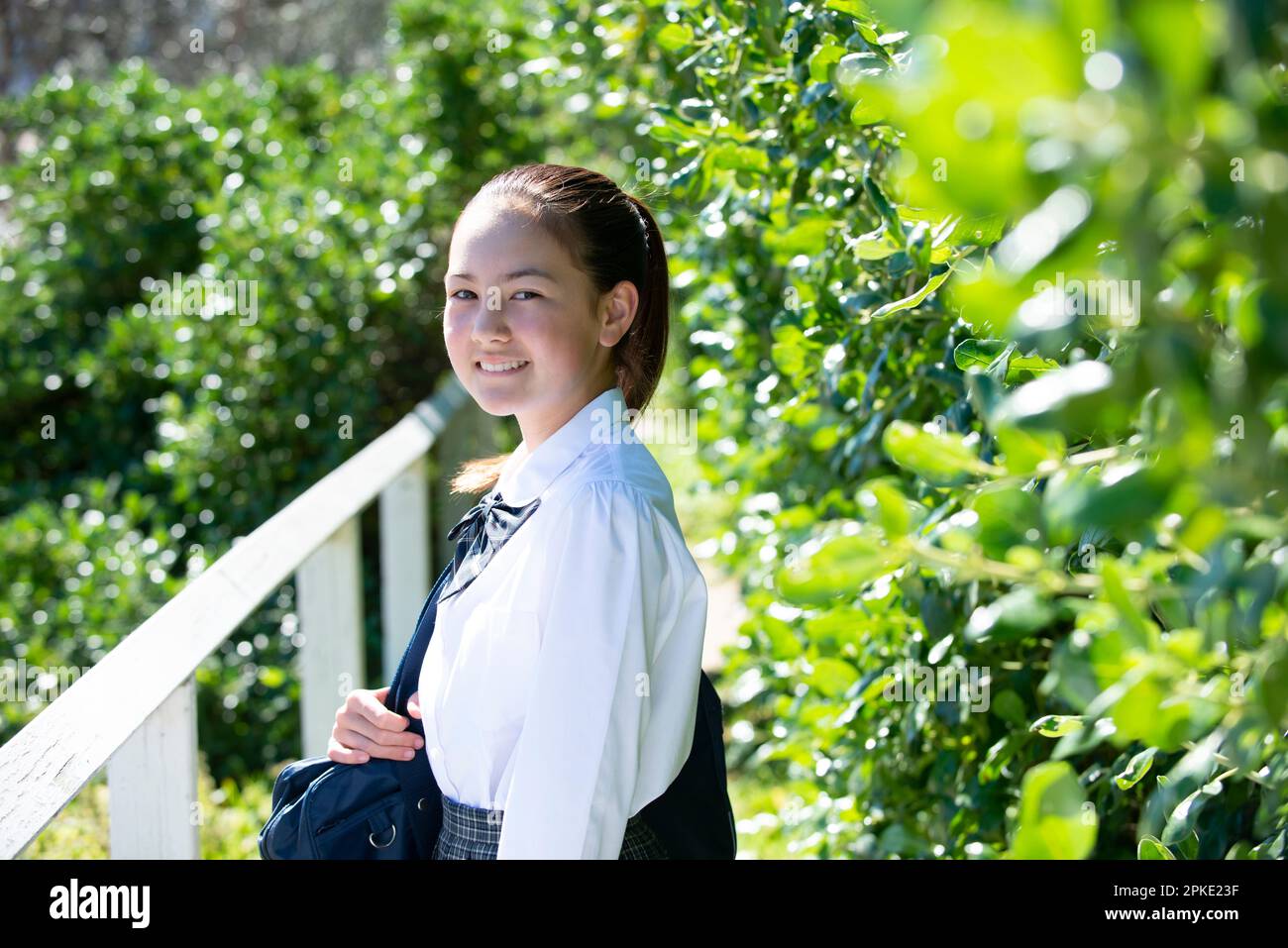 Female student in school uniform looking back Stock Photo - Alamy