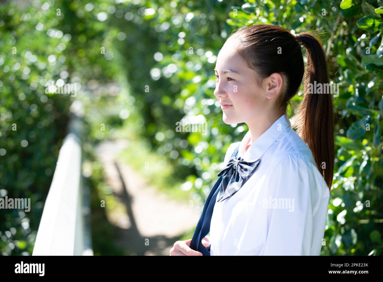 Female student in school uniform looking into the distance Stock Photo ...