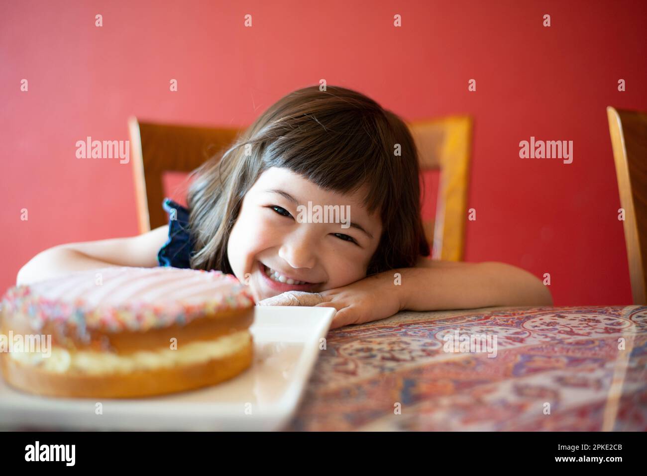 Girl laughing with cake Stock Photo - Alamy