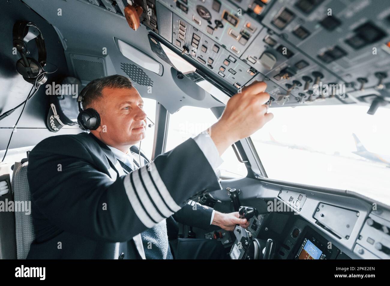 Side view. A professional pilot is in the cockpit. Conception of work ...