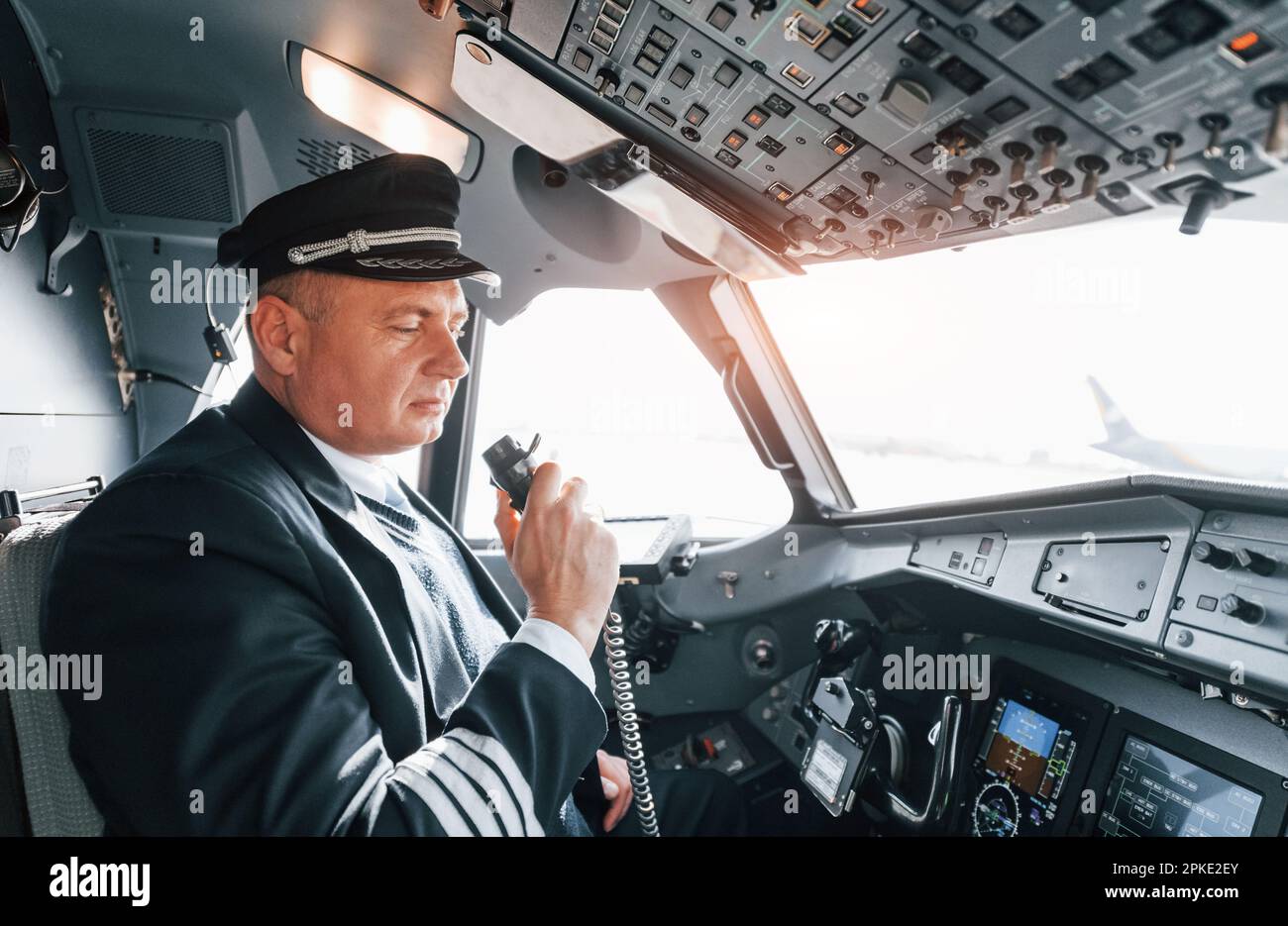 A professional pilot is in the cockpit. Conception of work Stock Photo ...