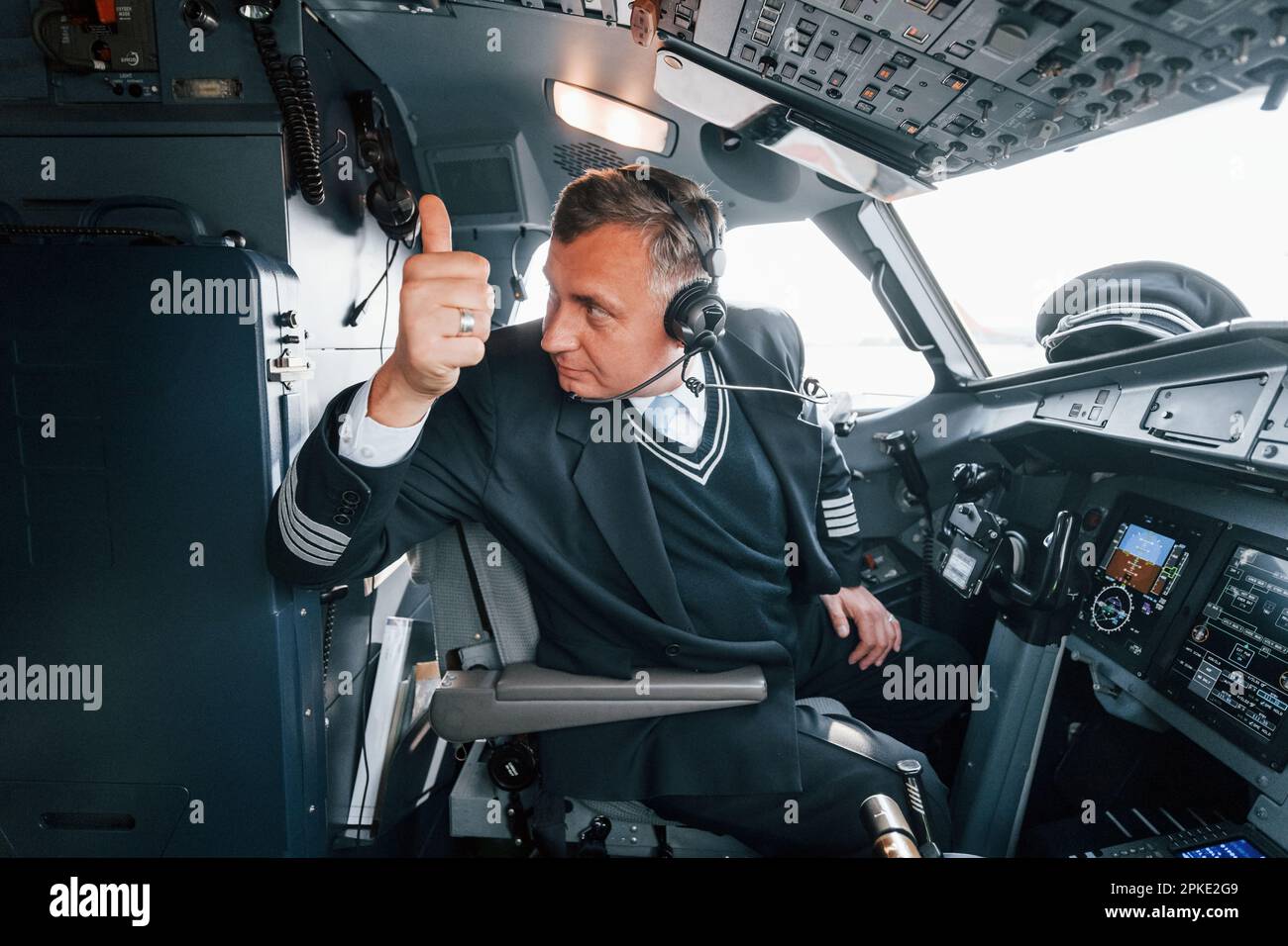 Side view. A professional pilot is in the cockpit. Conception of work ...